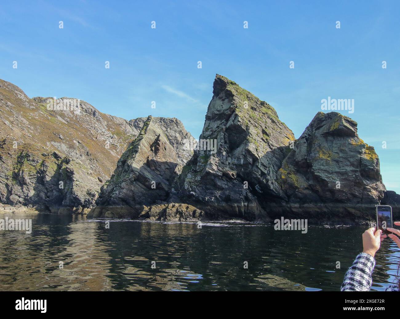 Taking picture on mobile phone of coast of County Donegal odd shaped ...