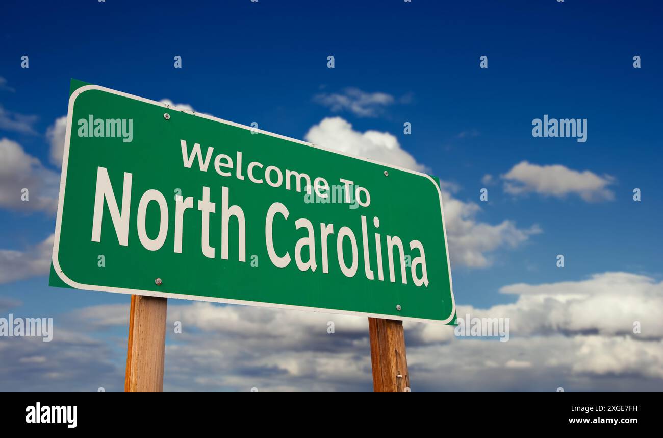 Welcome To North Carolina Green Road Sign Over Blue Sky with Some ...