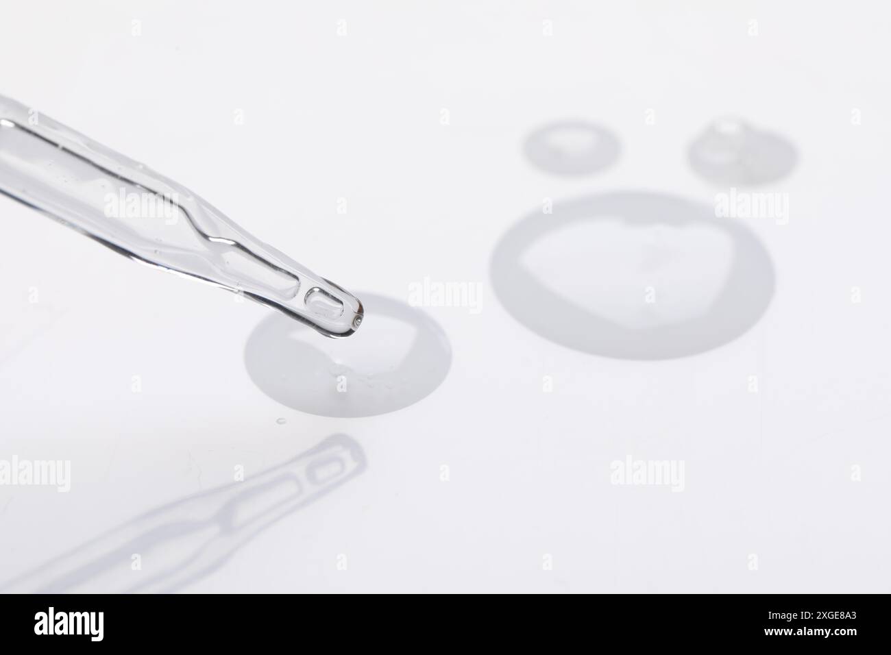 Glass pipette and transparent liquid on white background, closeup Stock ...