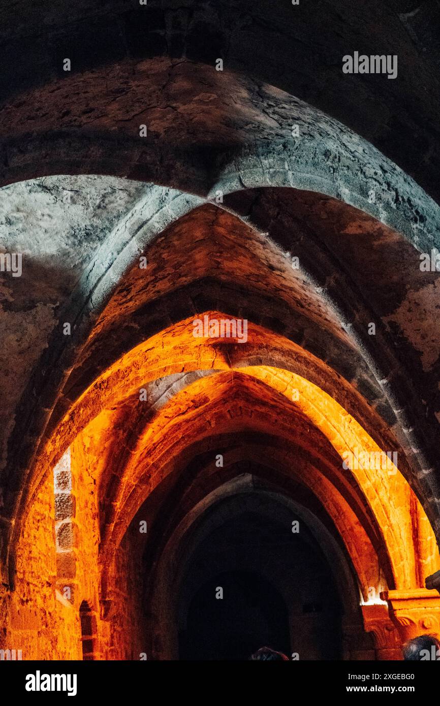A beautifully lit archway in an ancient stone castle with dramatic ...