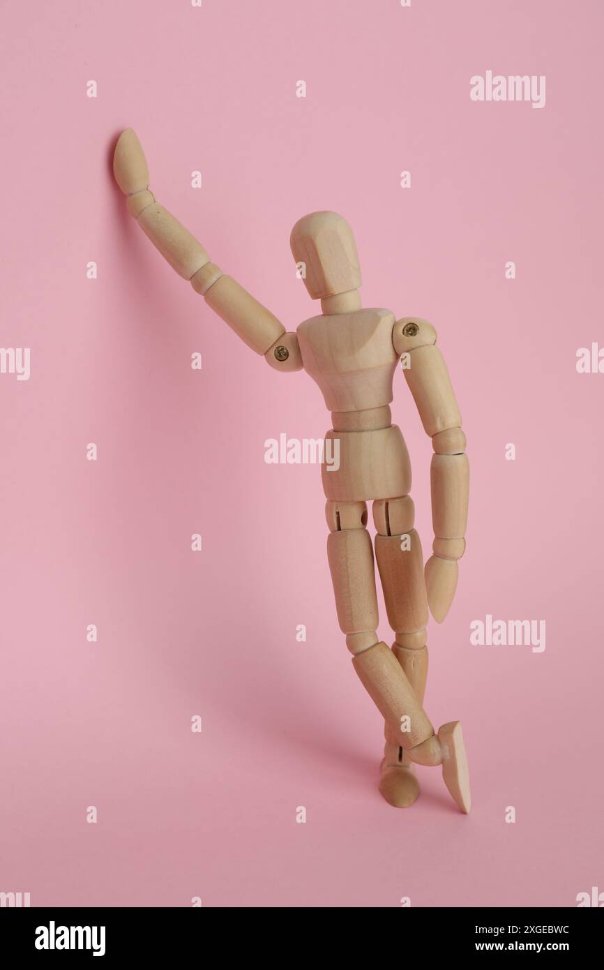 Wooden human model on pink background. Mini mannequin Stock Photo - Alamy