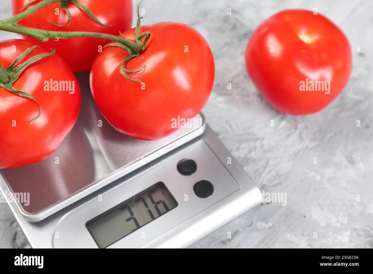 Kitchen scale with tomatoes on grey textured table, closeup Stock Photo ...