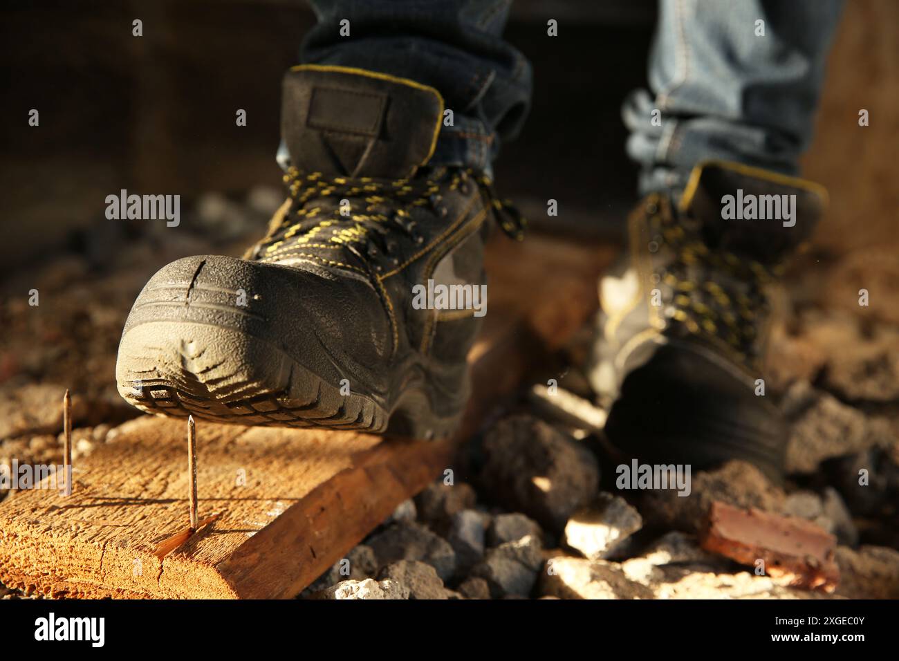 Careless worker stepping on nails in wooden plank, closeup Stock Photo ...