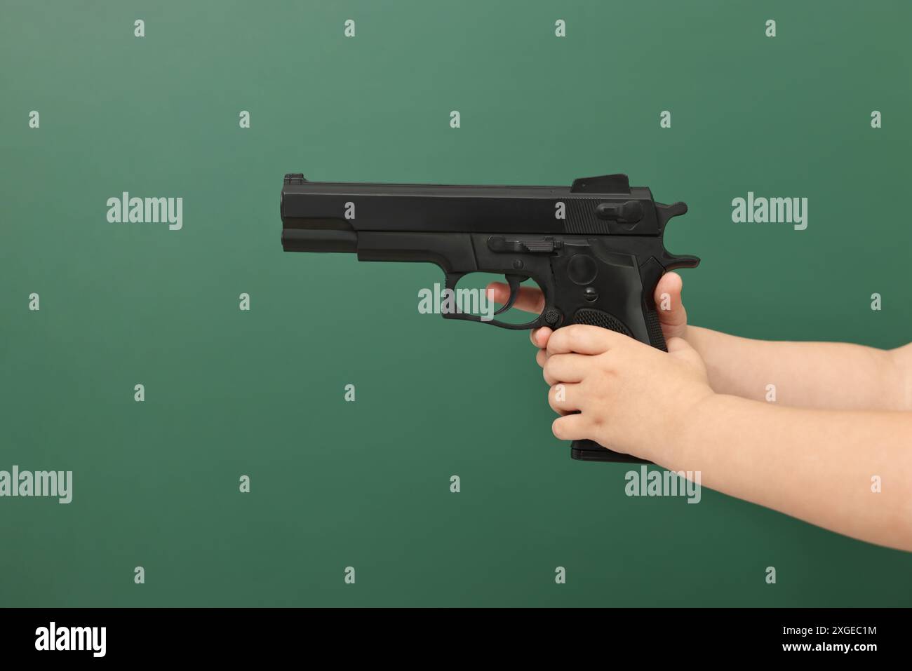 Child with gun against chalkboard, closeup. School shooting Stock Photo ...