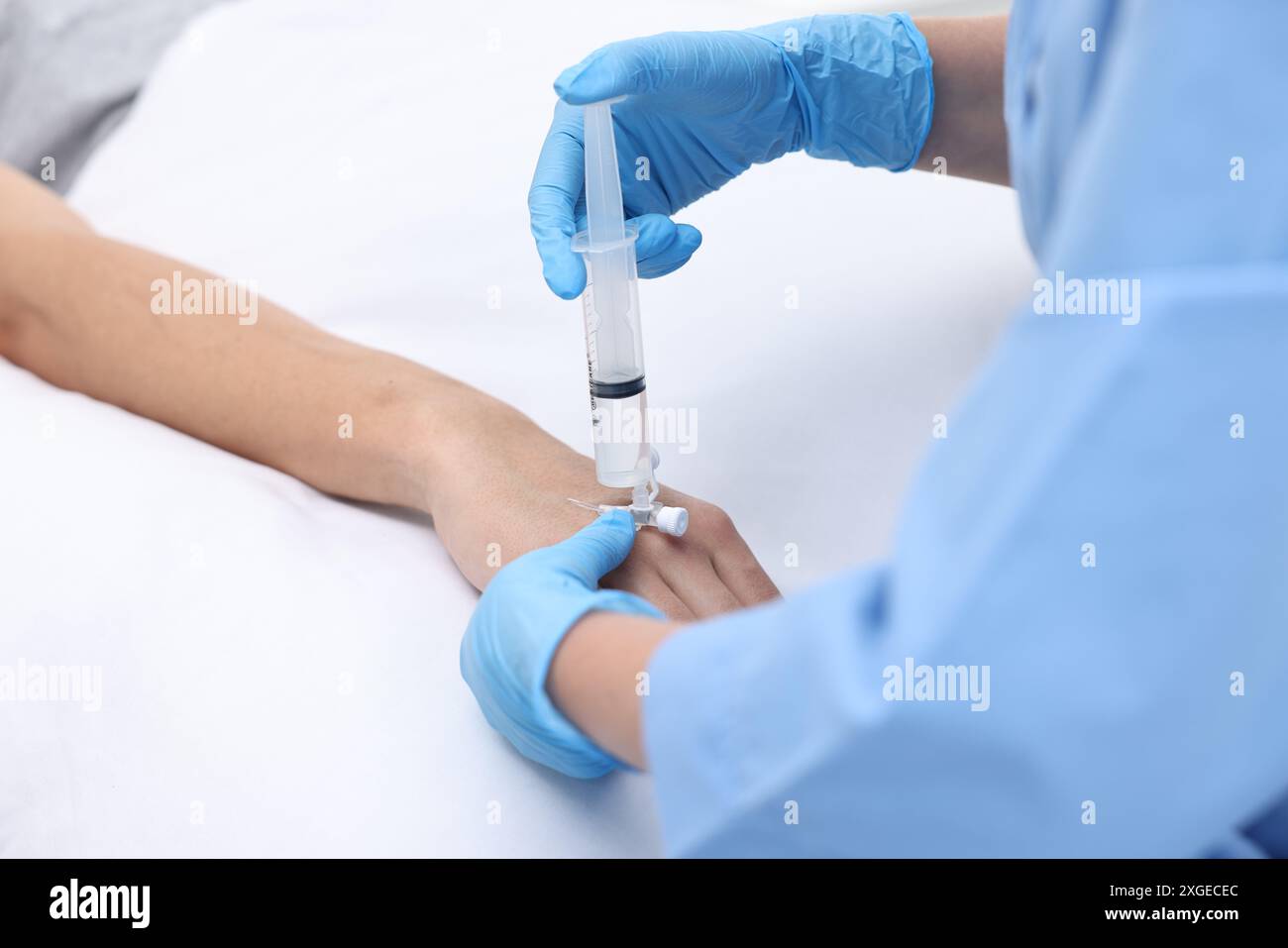 Nurse inserting IV into arm of patient in hospital, closeup Stock Photo ...