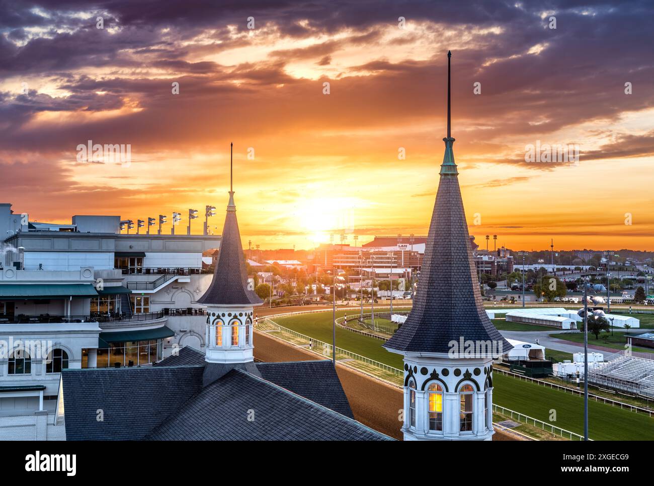 A stunning view of Churchill Downs racetrack at sunset with a colorful ...