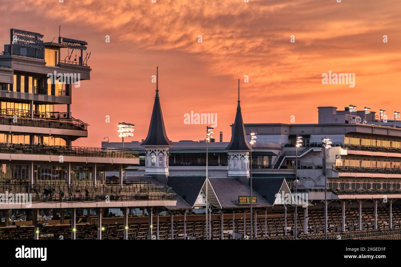 A stunning view of Churchill Downs racetrack at sunset with a colorful ...