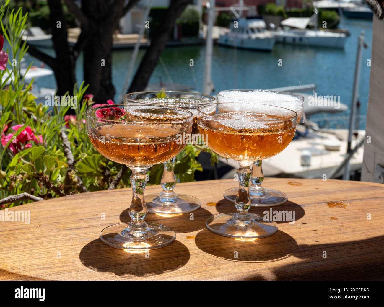 French brut rose champagne sparkling wine in coupe glasses in yacht ...