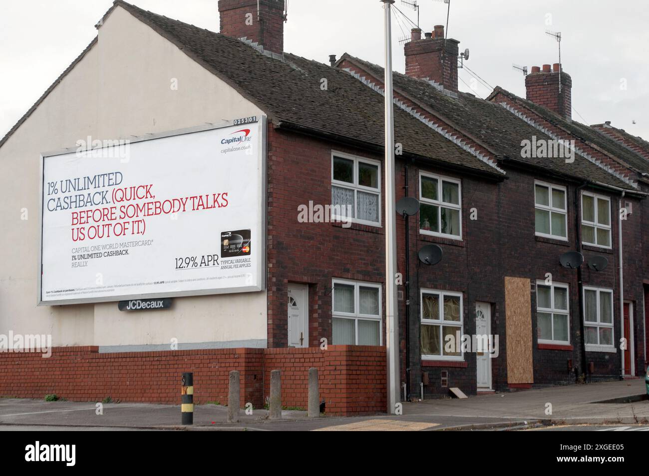 Billboard with advert for Capital One Master card on end wall of row of ...