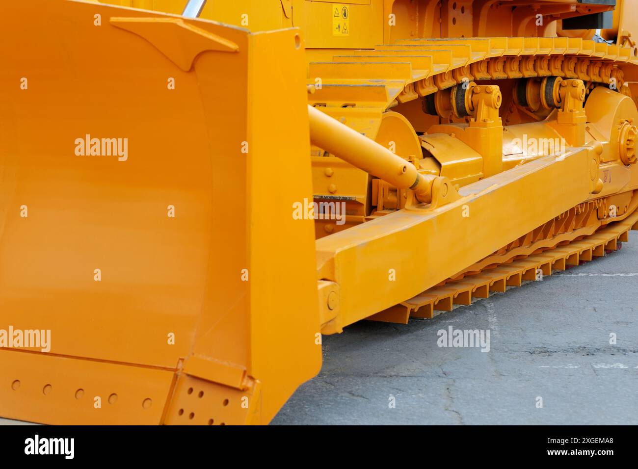 Close-up side view of a tracked heavy bulldozer. Industrial ...