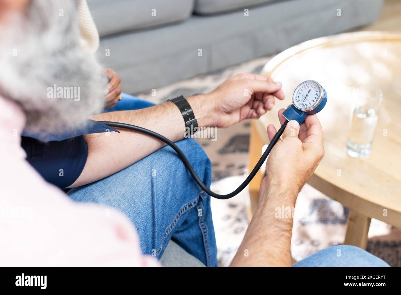 Measuring blood pressure, senior man using sphygmomanometer at home ...