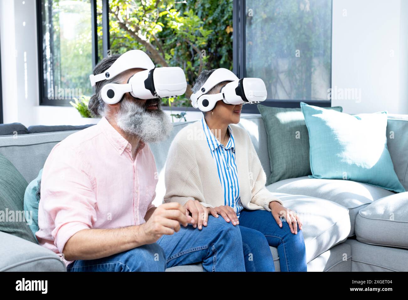 Using VR headsets, senior couple exploring virtual reality while ...