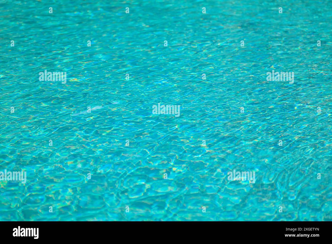 Swimming pool rippled water with sun reflections. Abstract background ...
