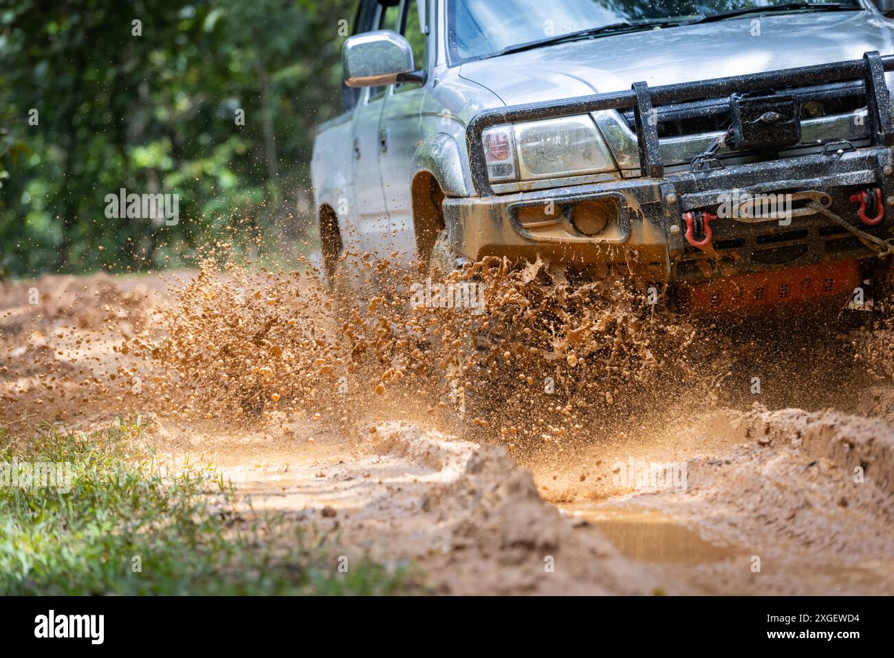 Cars running on off-road roads and splashing mud on natural paths. Off ...