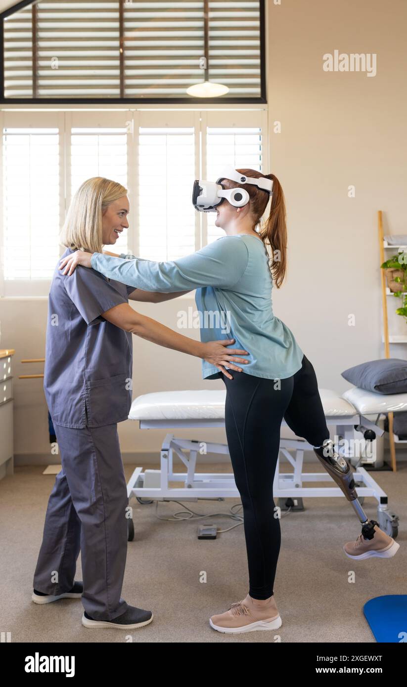 Woman in prosthetic leg using VR headset with therapist for balance ...