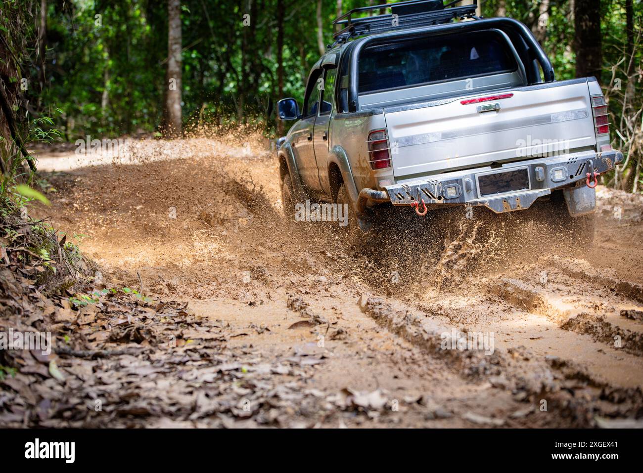 Cars running on off-road roads and splashing mud on natural paths. Off-road travel on muddy road ...