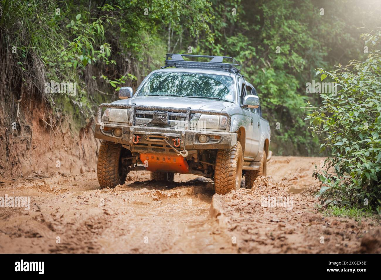 Cars running on off-road roads and splashing mud on natural paths. Off ...