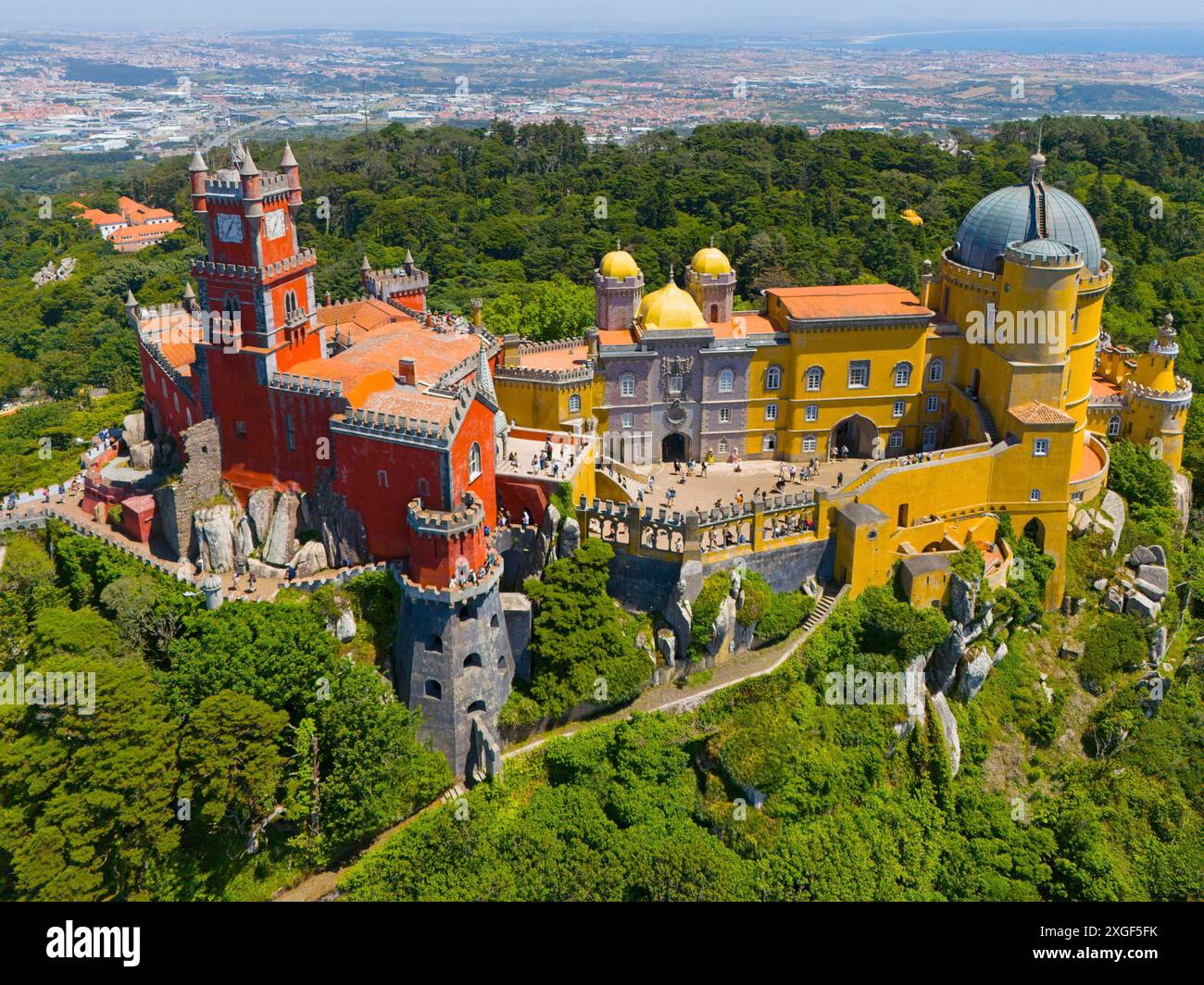 Colourful palace with yellow and red buildings, dome and towers ...