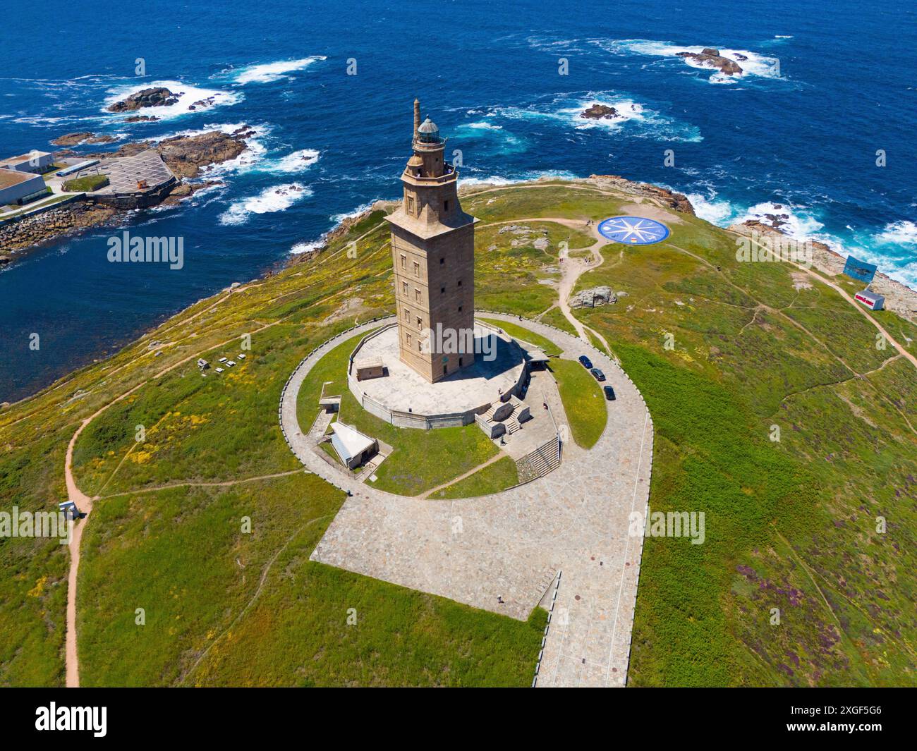 Majestic lighthouse on the coast with green grass and deep blue sea ...