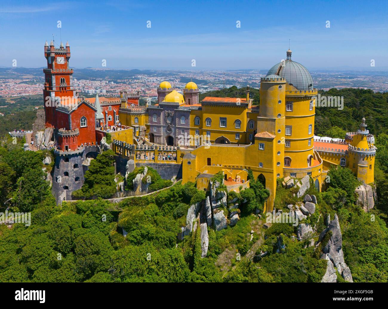 Magnificent castle with colourful towers and buildings in a green ...