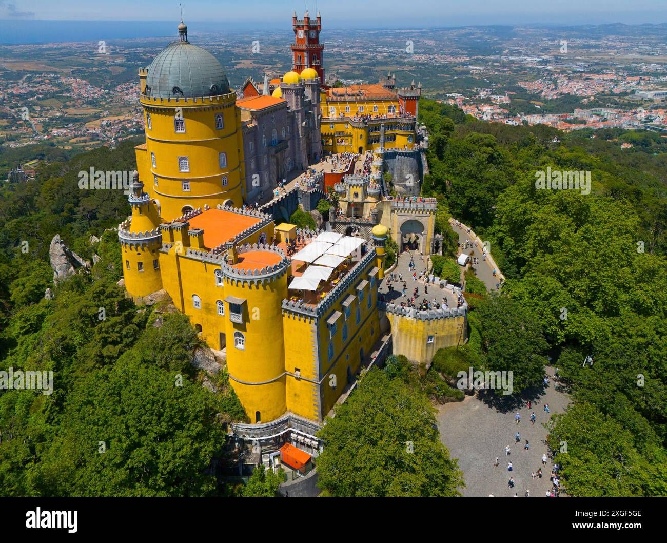 Historic castle in yellow on a hill with an impressive view and ...