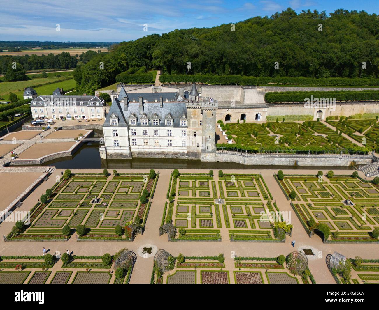 Historic castle with ornate gardens and parkland in geometric patterns ...