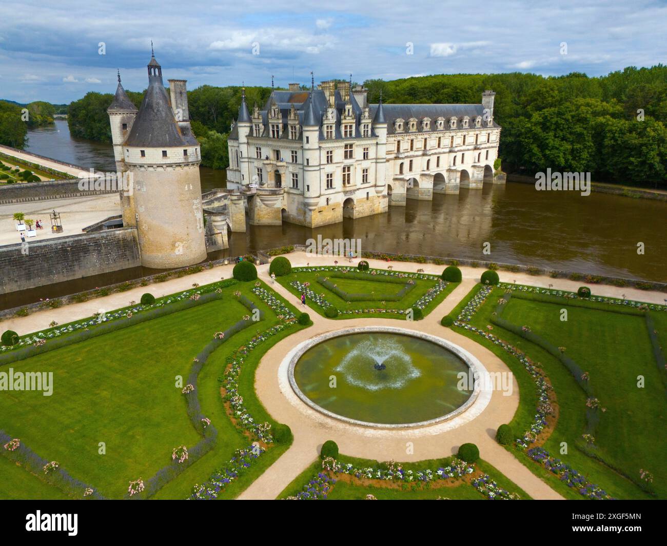 Castle and gardens with central fountain and geometric gardens by the ...