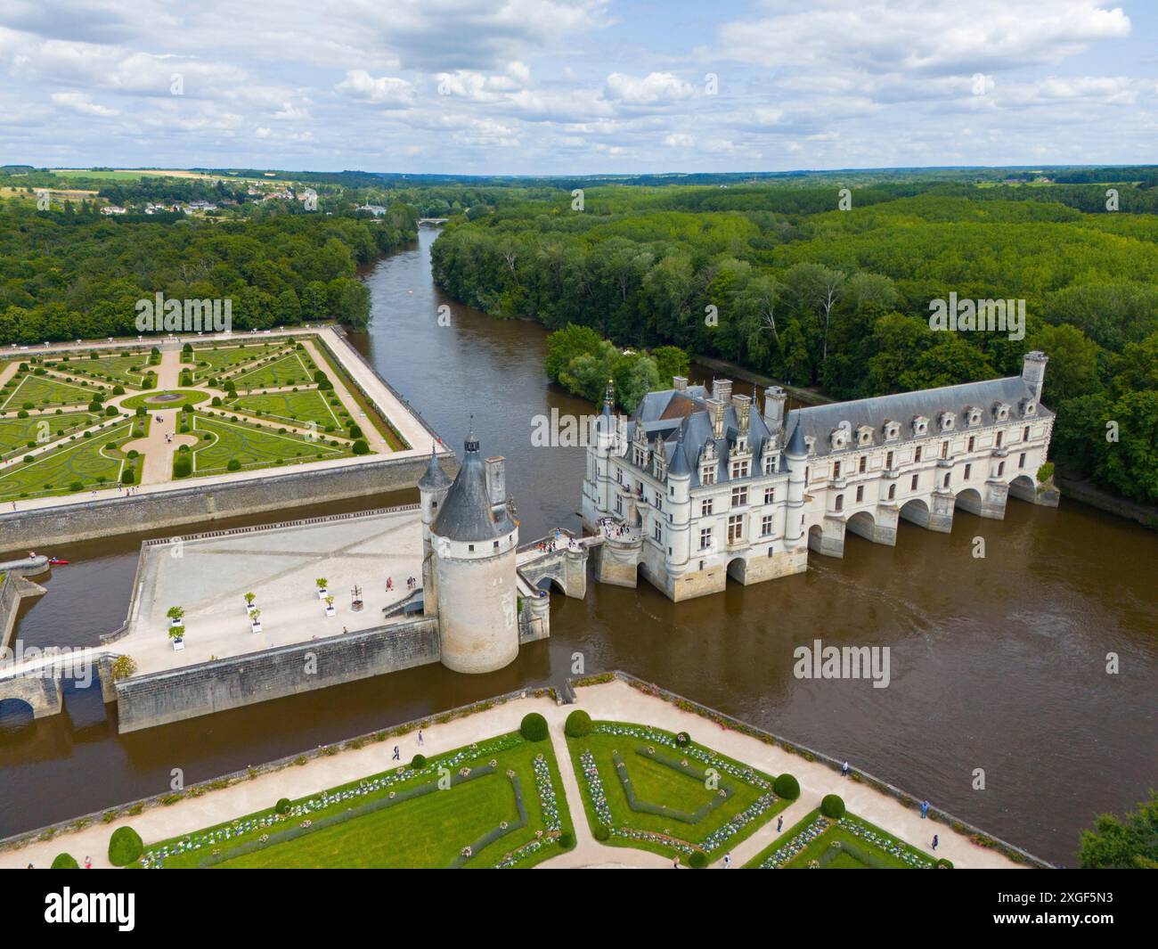 Aerial view of a castle on the river Cher with surrounding geometric gardens and forest ...