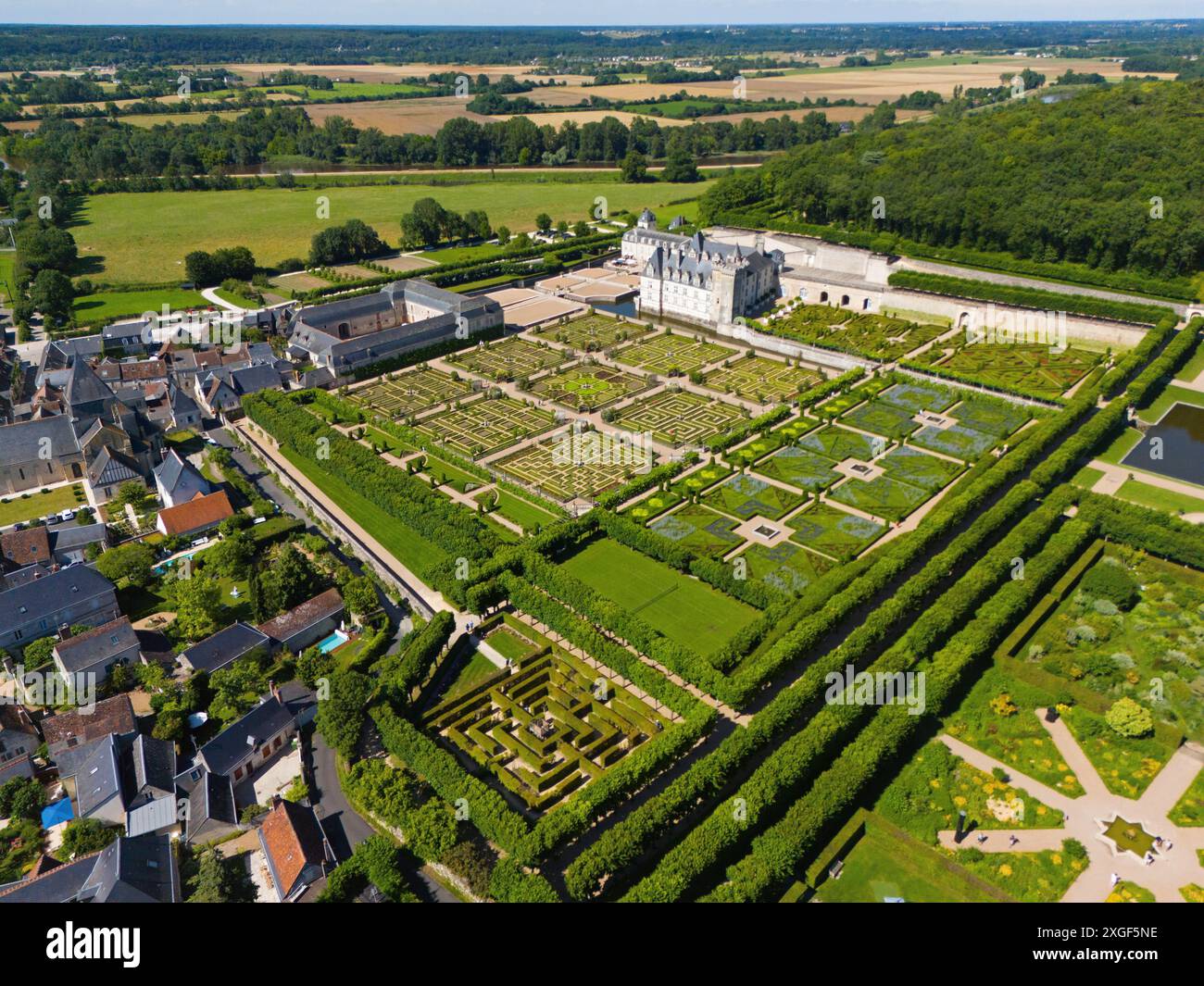 Extensive gardens of a castle with geometric patterns, surrounded by ...