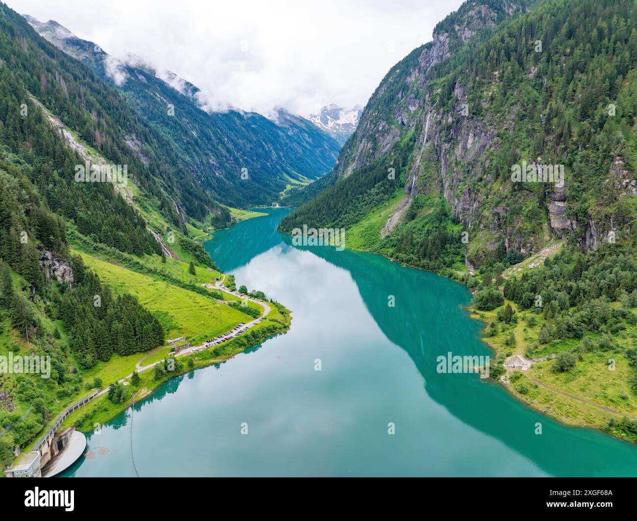 An idyllic mountain lake, surrounded by mountains and lush greenery ...