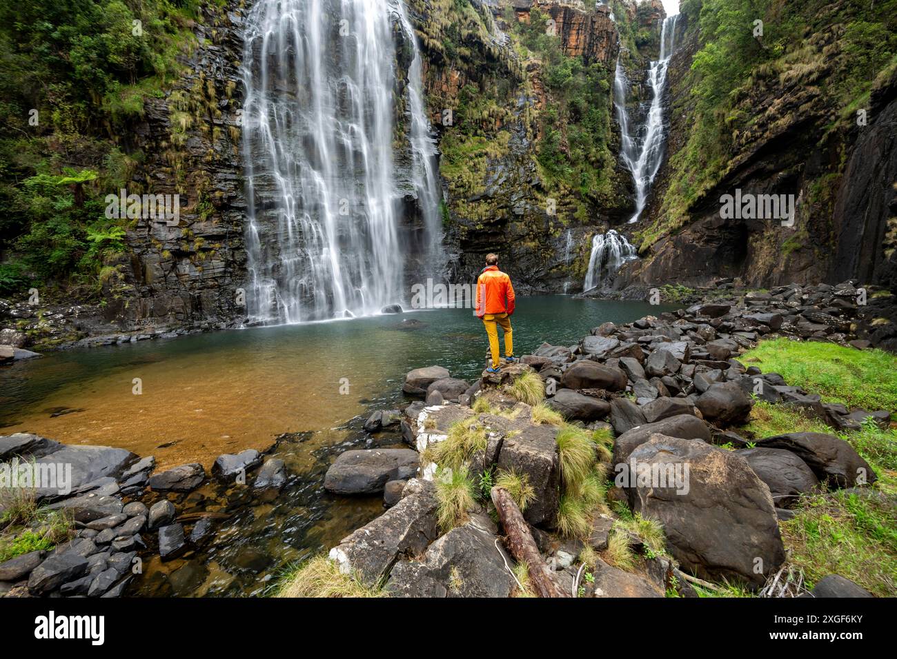 Young man standing in front of a waterfall, Lisbon Falls, long exposure ...