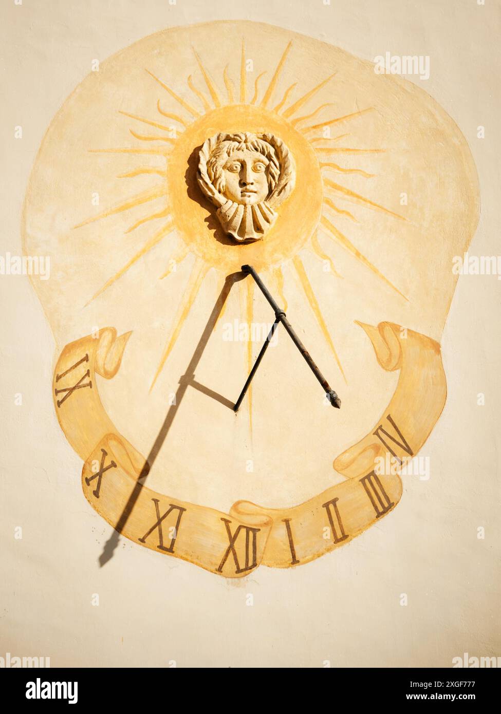 Sundial on a yellow wall Stock Photo - Alamy