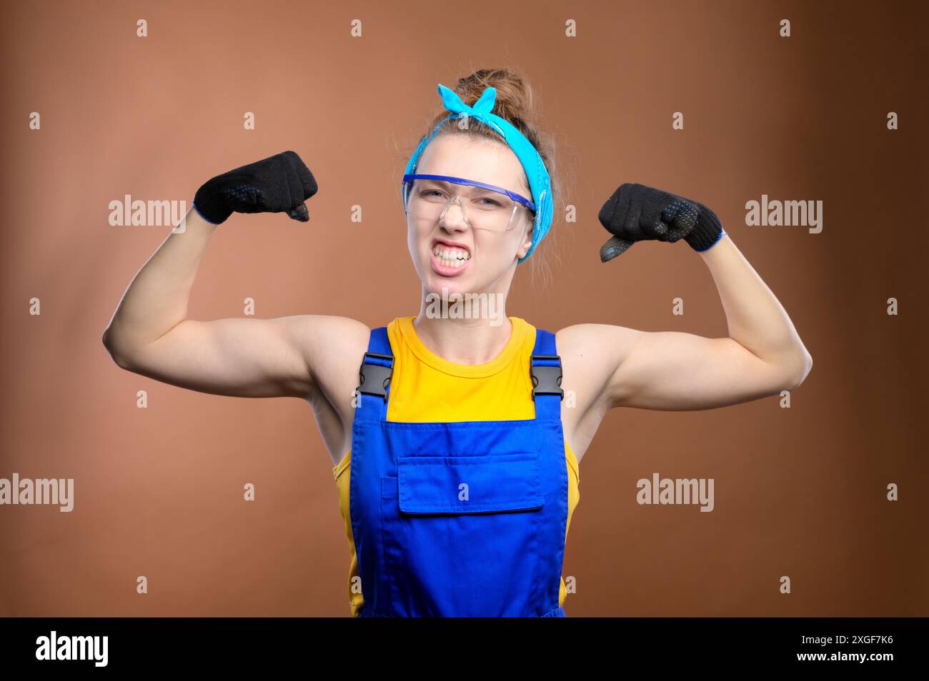 Portrait of a strong attractive Caucasian young woman in construction ...