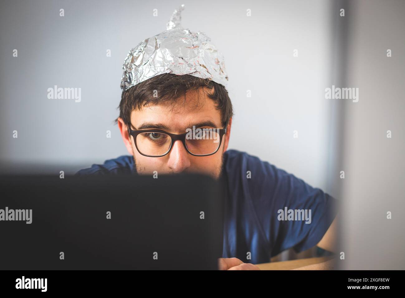 Young man is wearing aluminum cap, conspiracy theory concept Stock ...