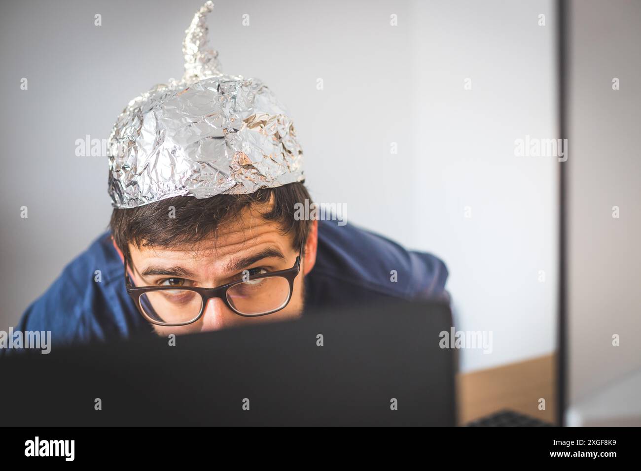 Young man is wearing aluminum cap, conspiracy theory concept Stock ...