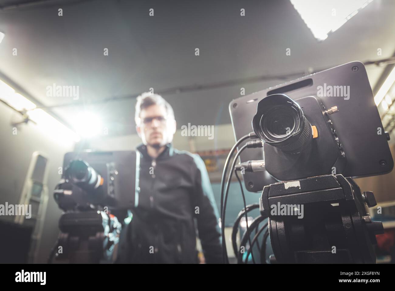 Male cameraman is operating a film camera in a television recording ...