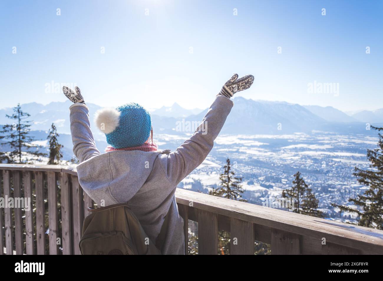Back of young woman who is raising her hands on the mountain, outlook ...