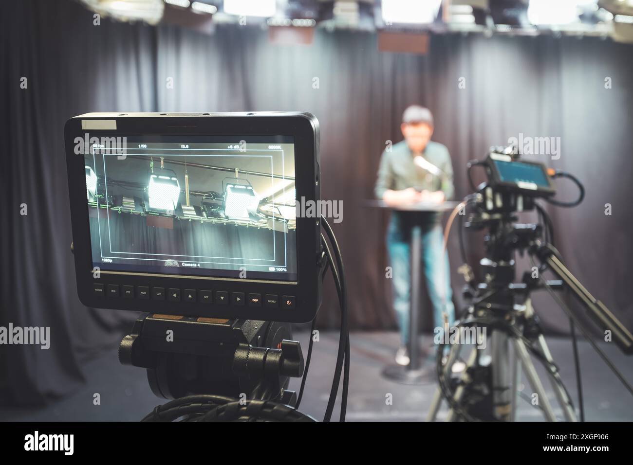 Male journalist in a television studio talks into a microphone, film ...