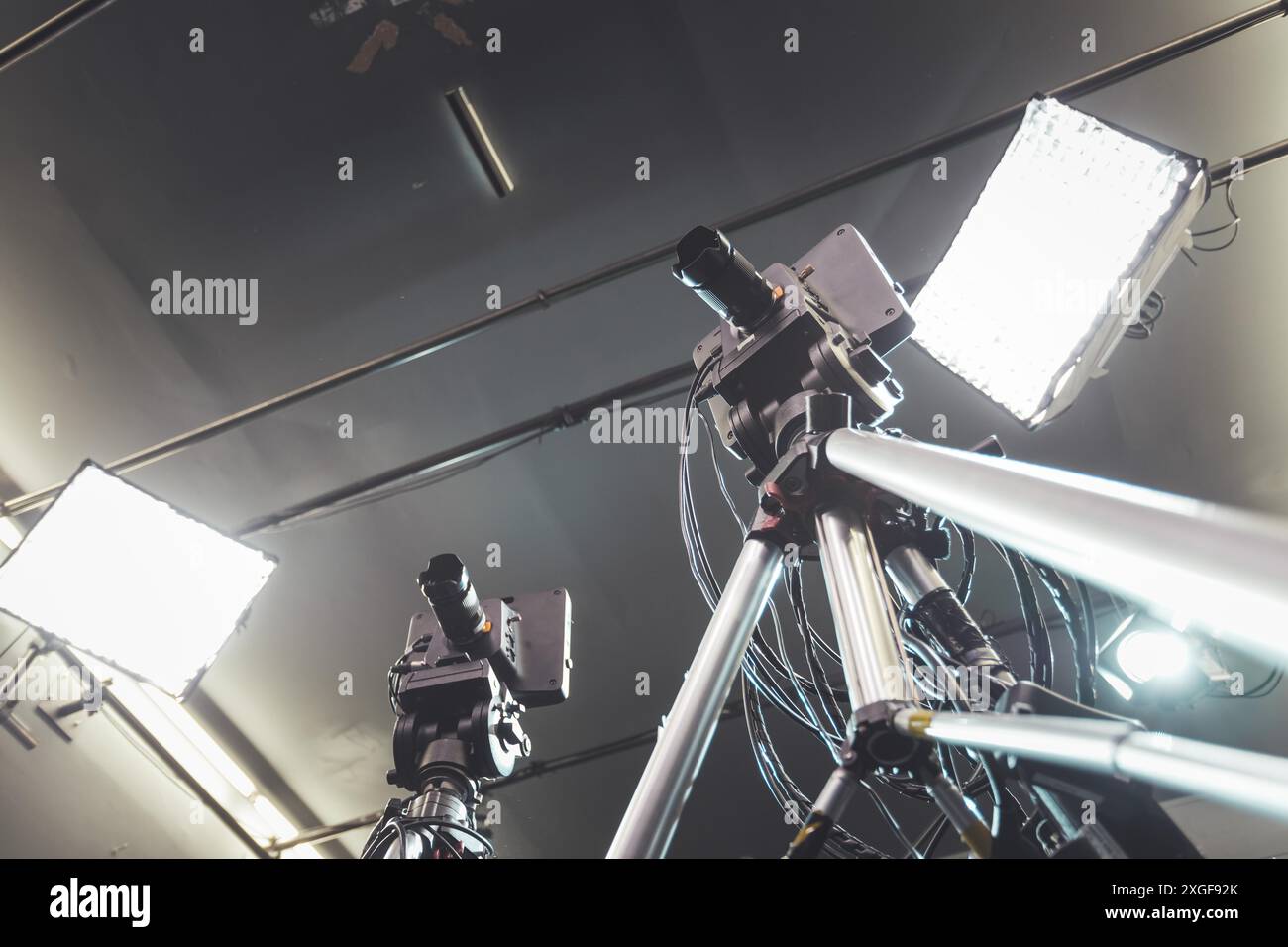 Film camera on a tripod in a television broadcasting studio, spotlights ...