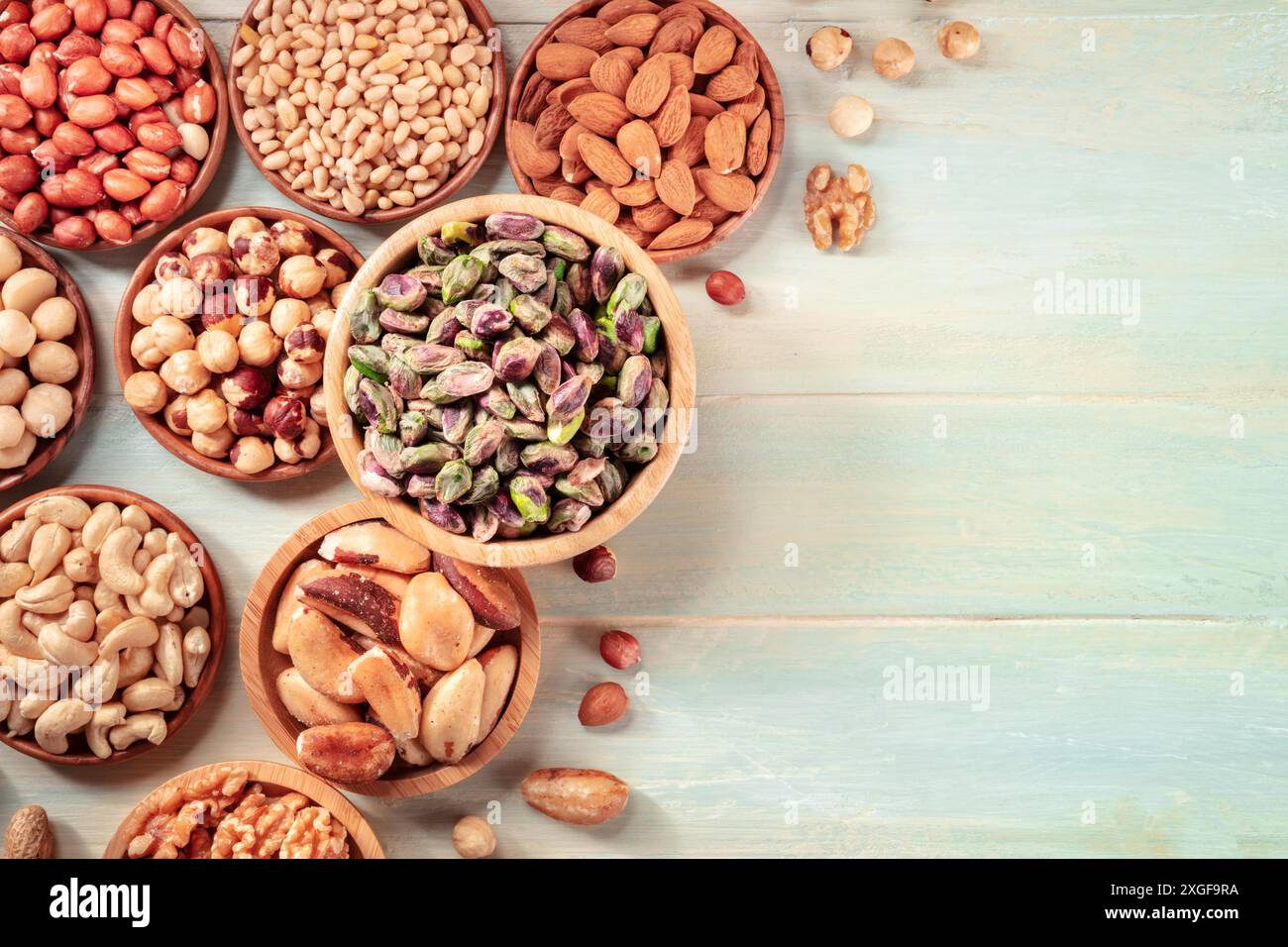 Nuts design layout with copy space. Pistachios, cashews, pine nuts and ...