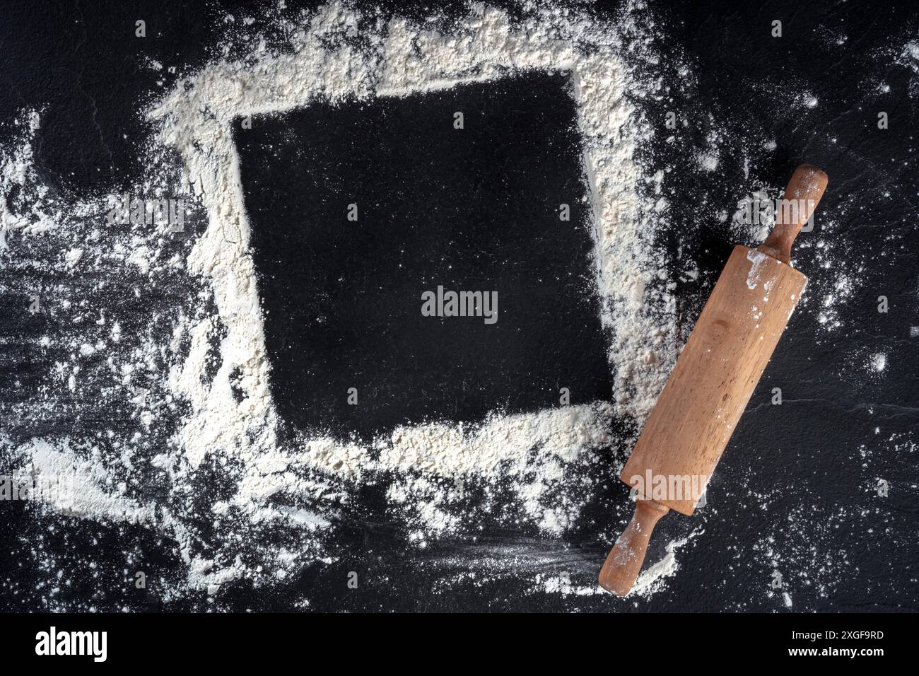 Baking frame with copy space, white flour and a wooden rolling pin, top ...