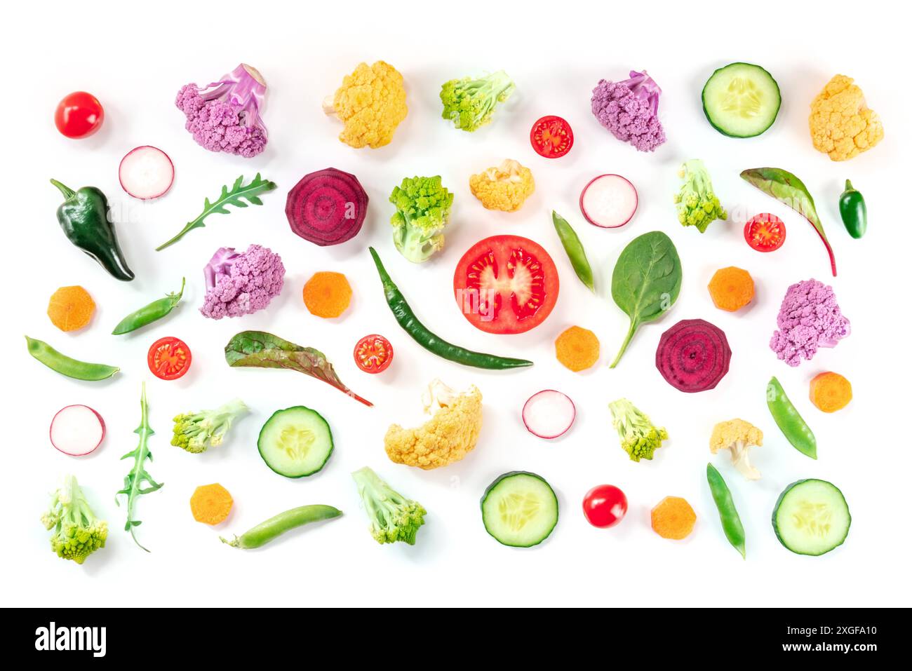 Many fresh vegetable slices, overhead flat lay shot on a white ...