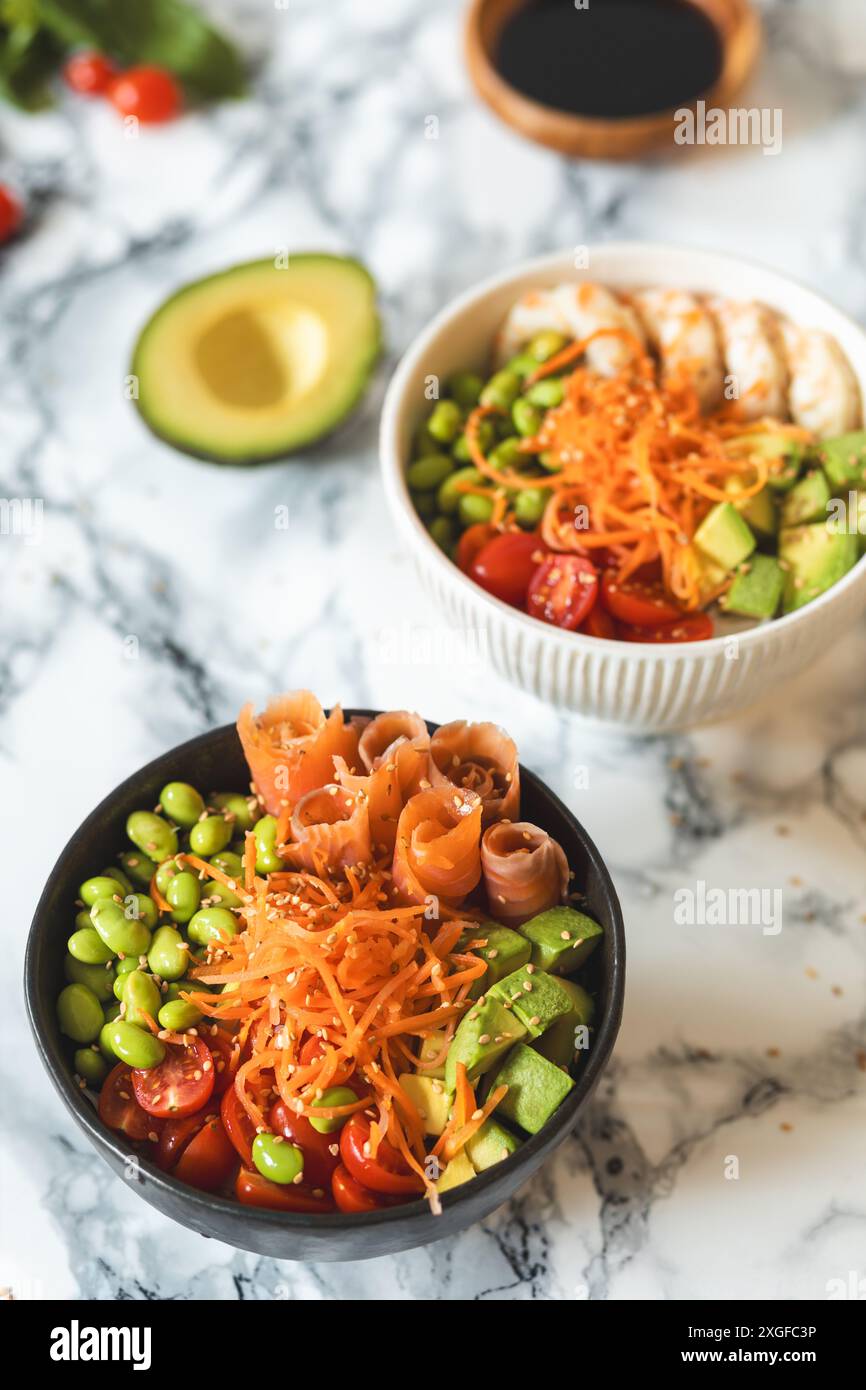 Delicious poke bowls with avocado, edamame, cherry tomatoes, shredded ...