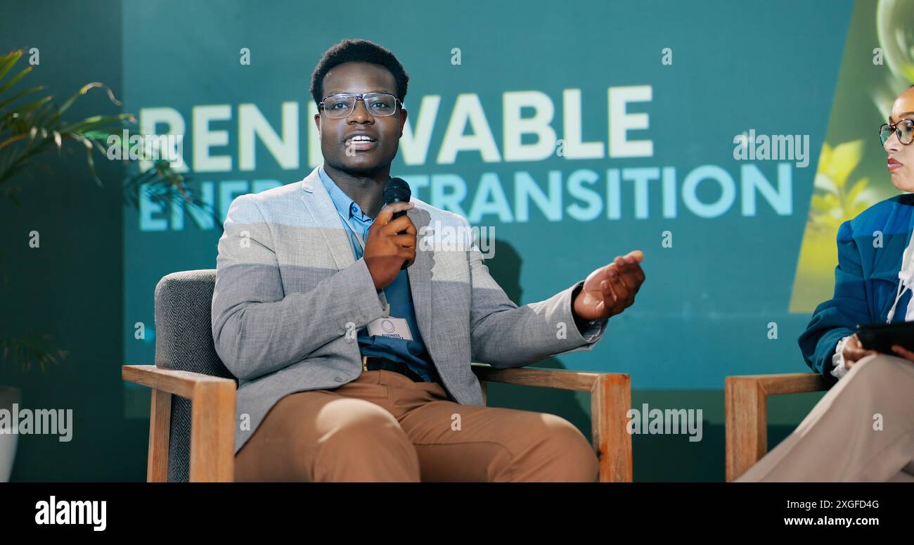 Man, woman and stage with conversation at conference for renewable ...