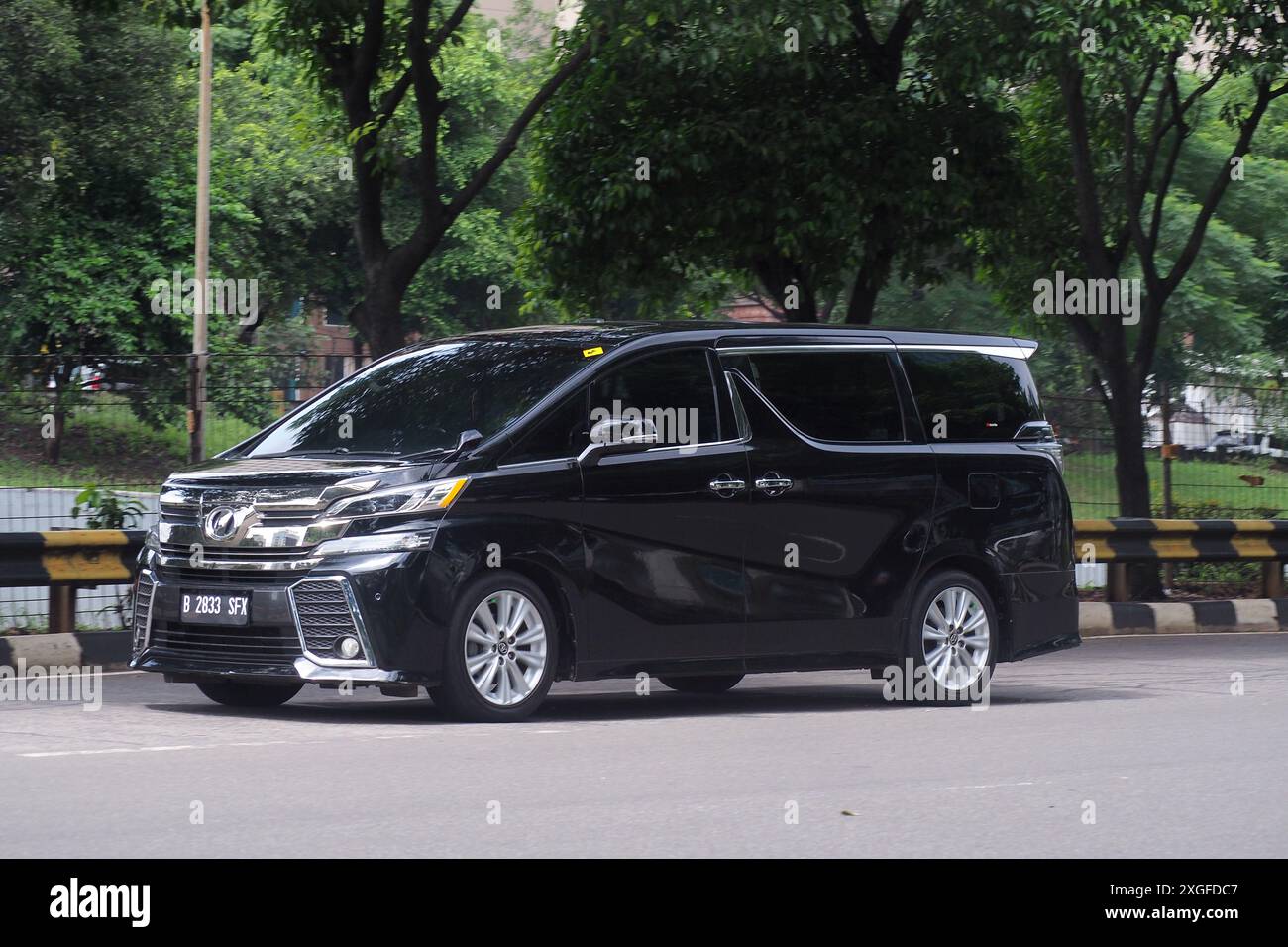 Luxury MPV, black Toyota Alphard in a road, at business and commercial distric TB Simatupang ...