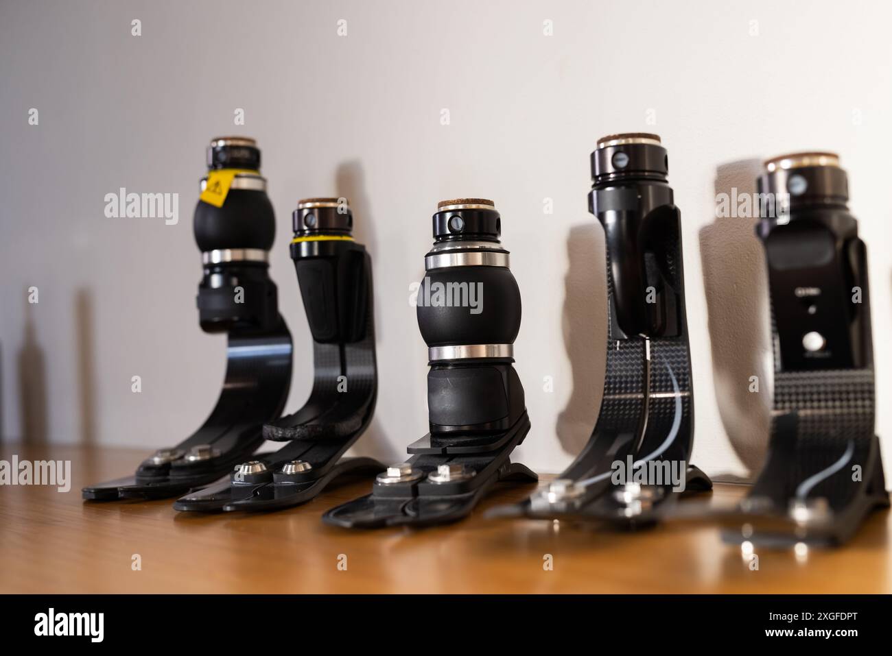 Prosthetic legs with advanced technology, displayed on wooden table in ...