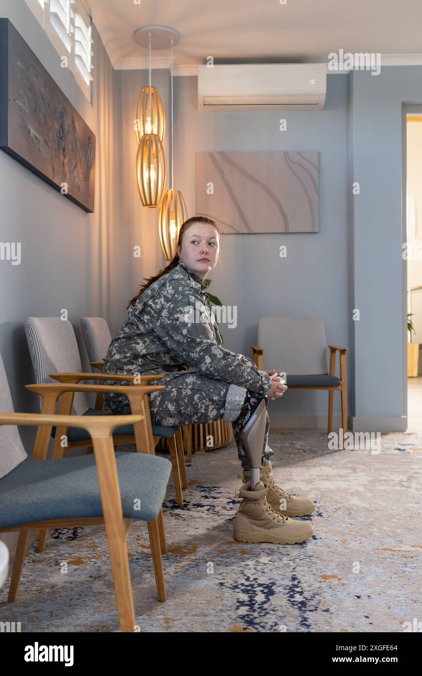 Sitting in waiting room, woman in undefined uniform with prosthetic leg ...