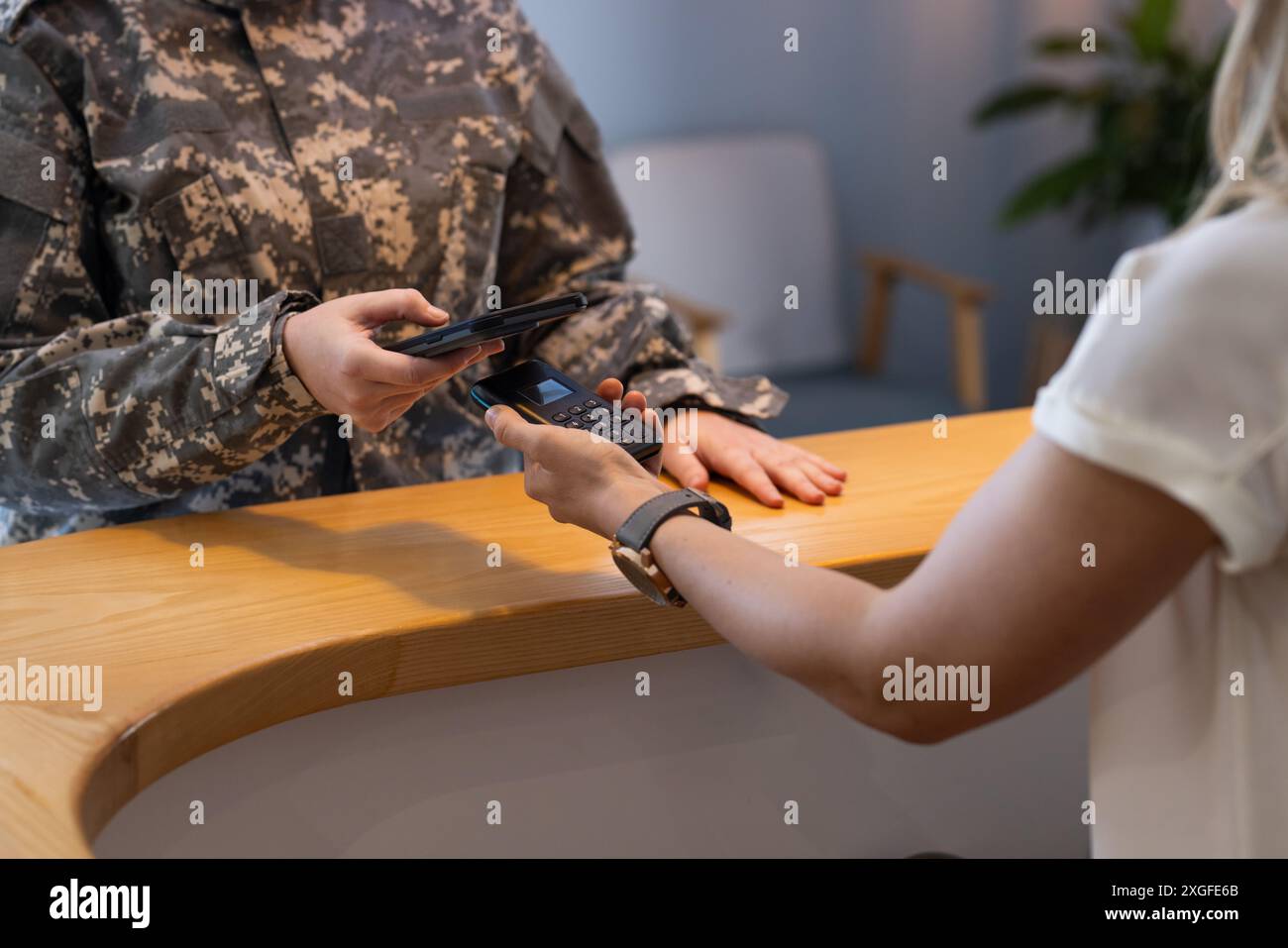 Using contactless payment, person in undefined uniform paying with ...