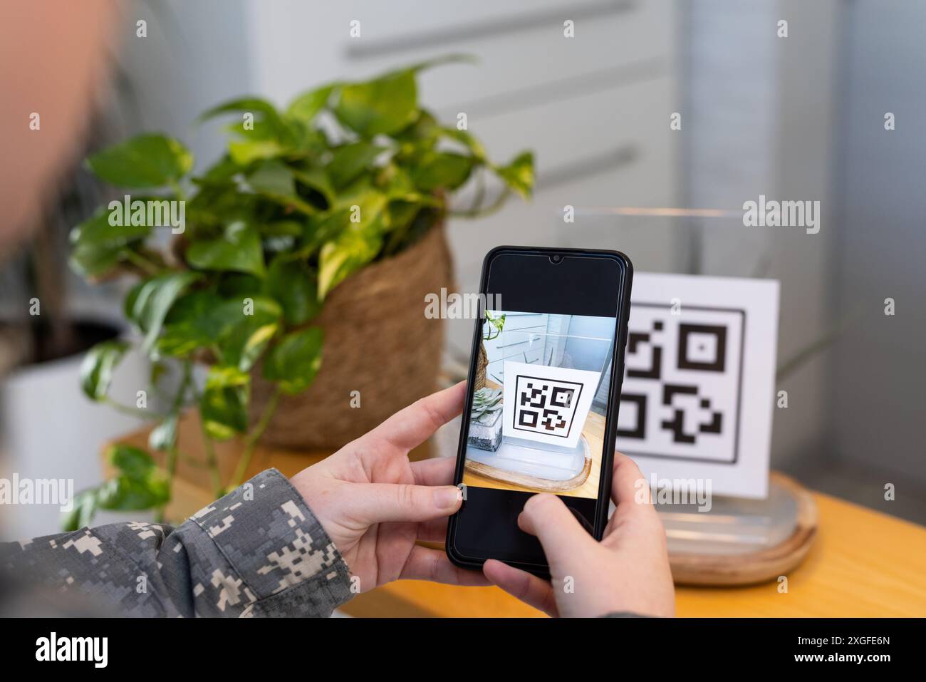 Scanning QR code with smartphone, person in medical clinic setting ...