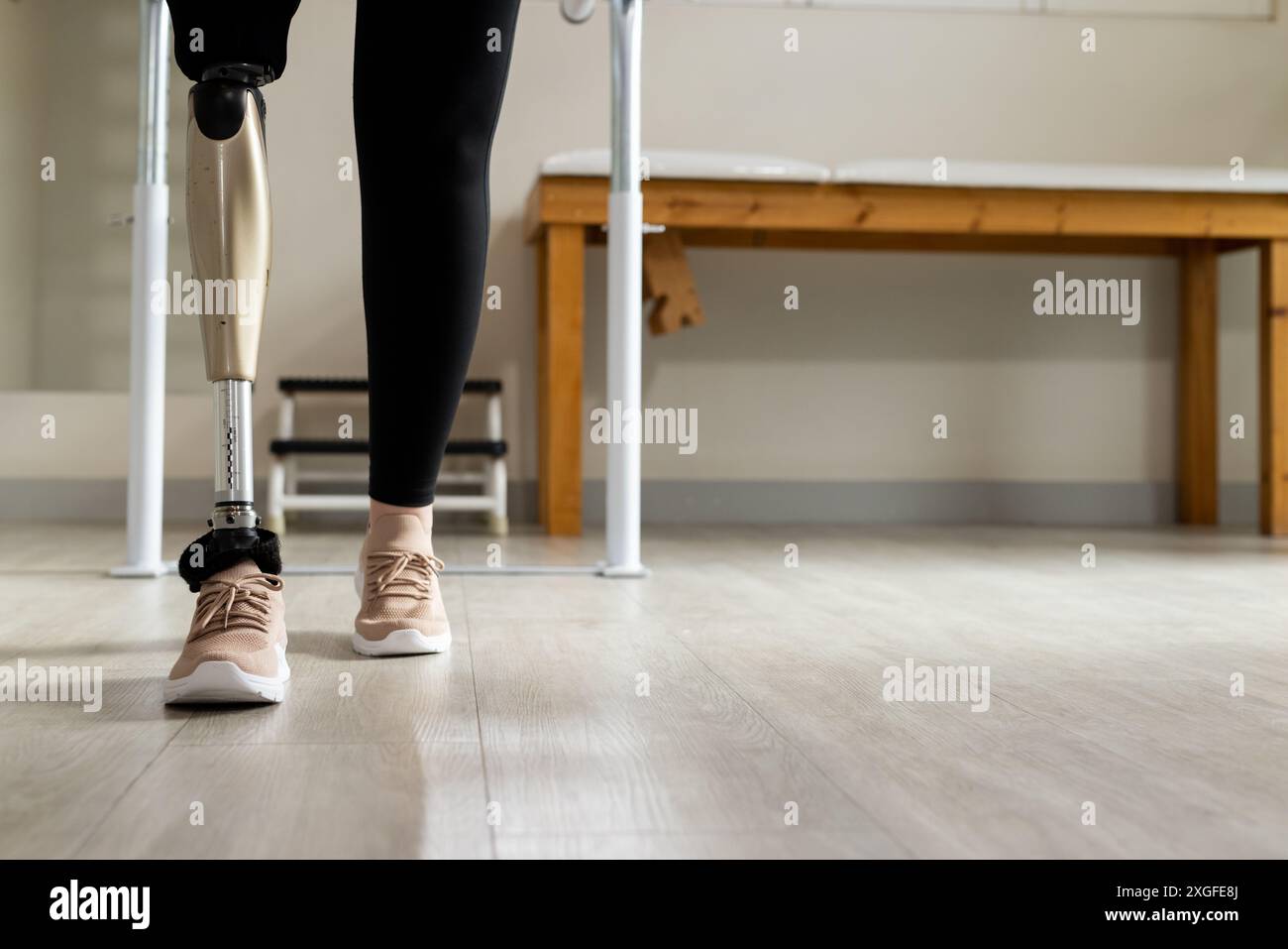 Walking with prosthetic leg, person in rehabilitation medical clinic ...